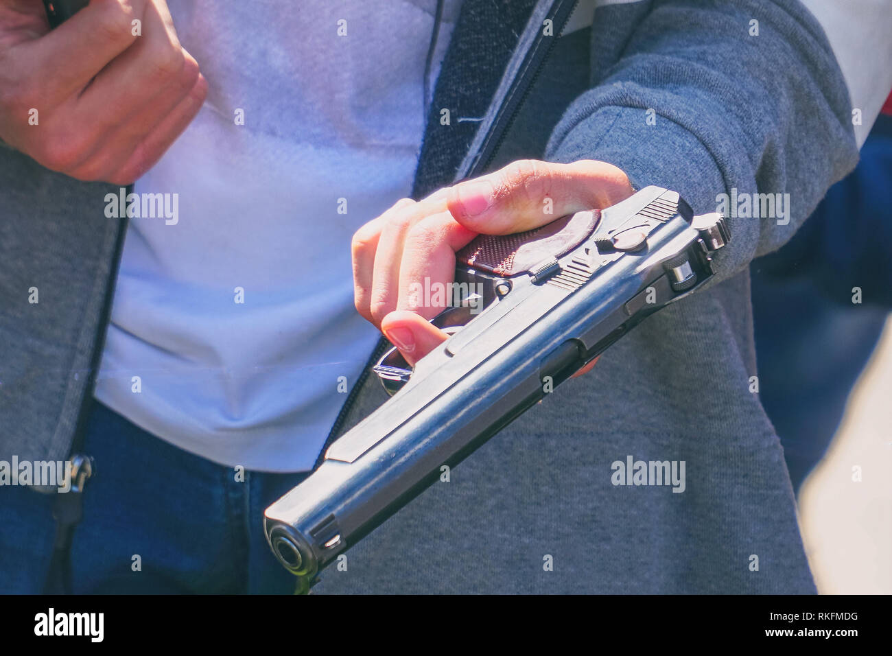 The gun in the man's hand Stock Photo - Alamy