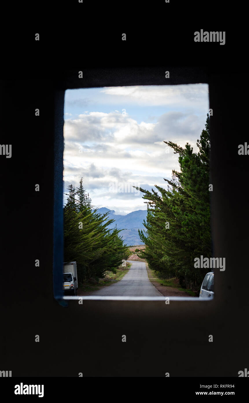 View through a rustic window, highway with a beautiful sky in Cusco ...