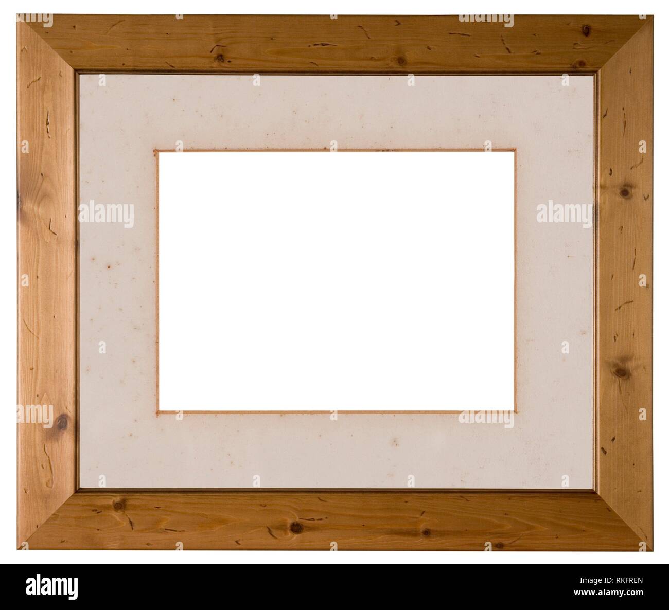 Empty pine wood picture frame with a heavily foxed mount isolated on ...