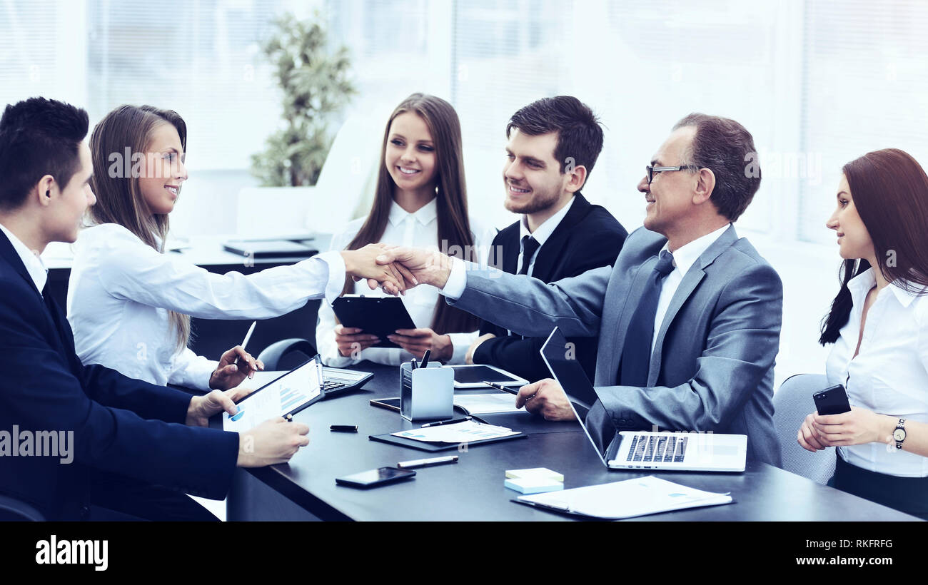 Business meeting at the table and handshake of partners Stock Photo - Alamy