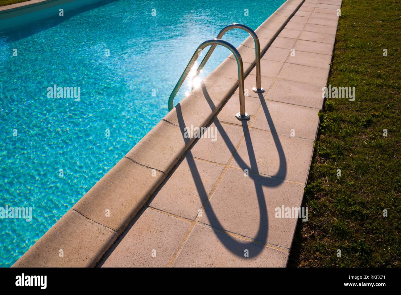 Graphic semi-abstract shape of outdoor swimming pool ladder shadows ...