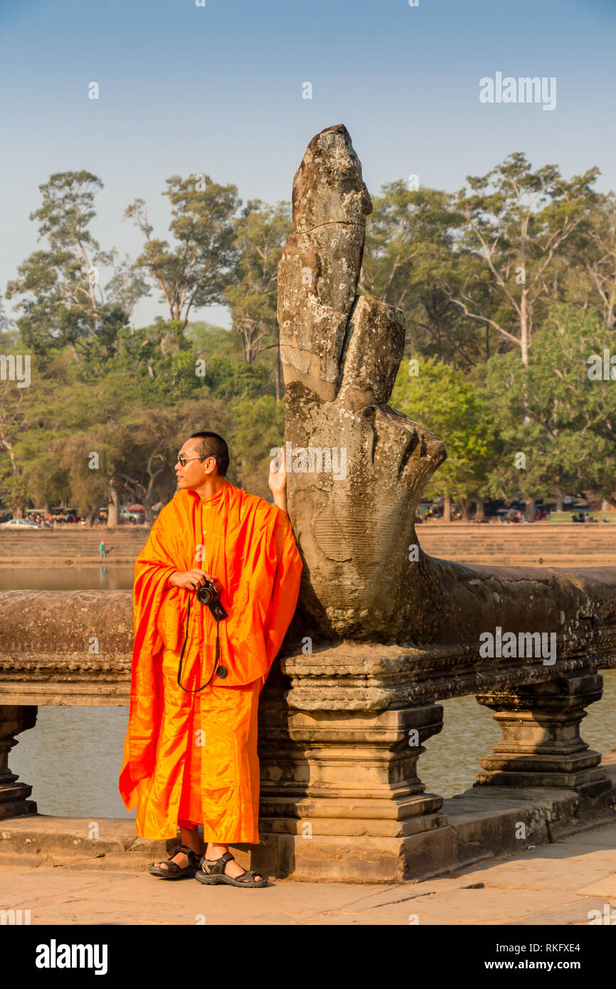 Buddhist monk wearing safron robes, uses the latest technology on his ...