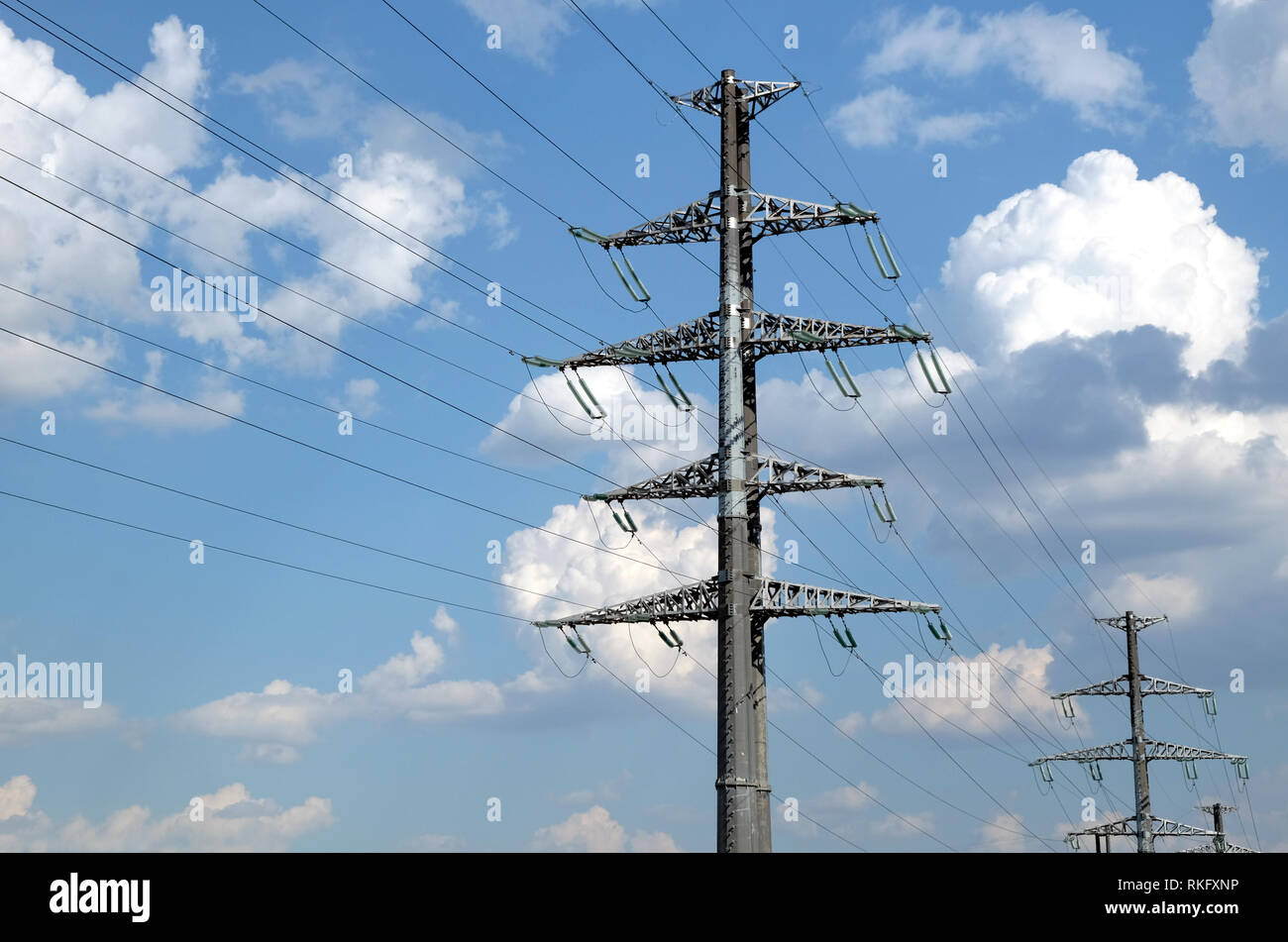 High-voltage power line gray metal props with many wires closeup view ...