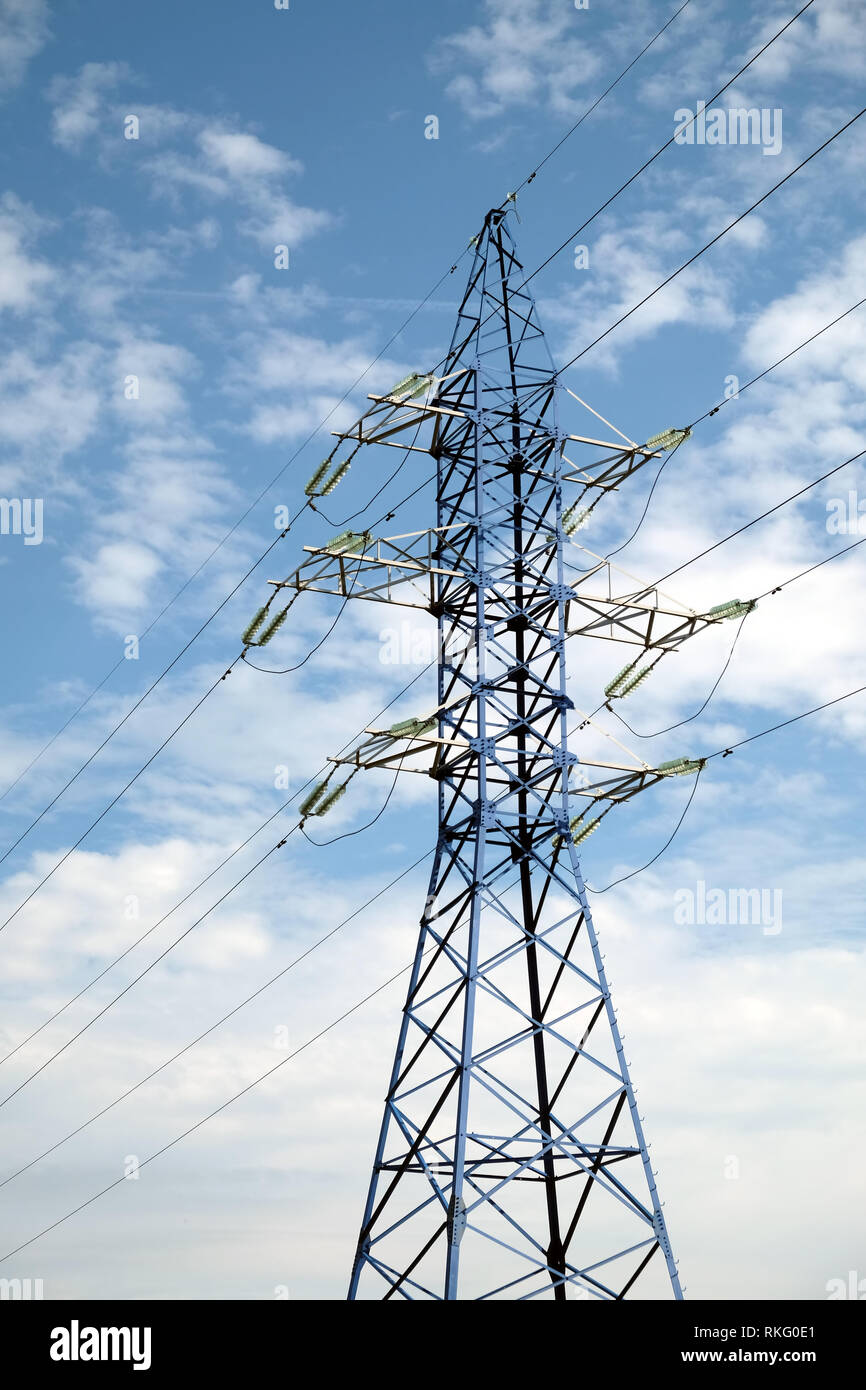 High-voltage power line and blue color metal prop with many electrical ...