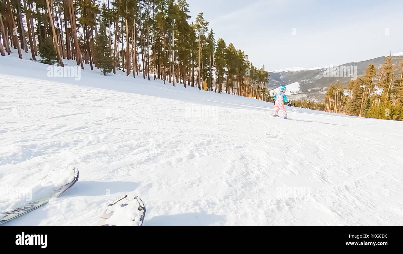 Little girl learning how to ski down the hill on alpine mountains Stock ...