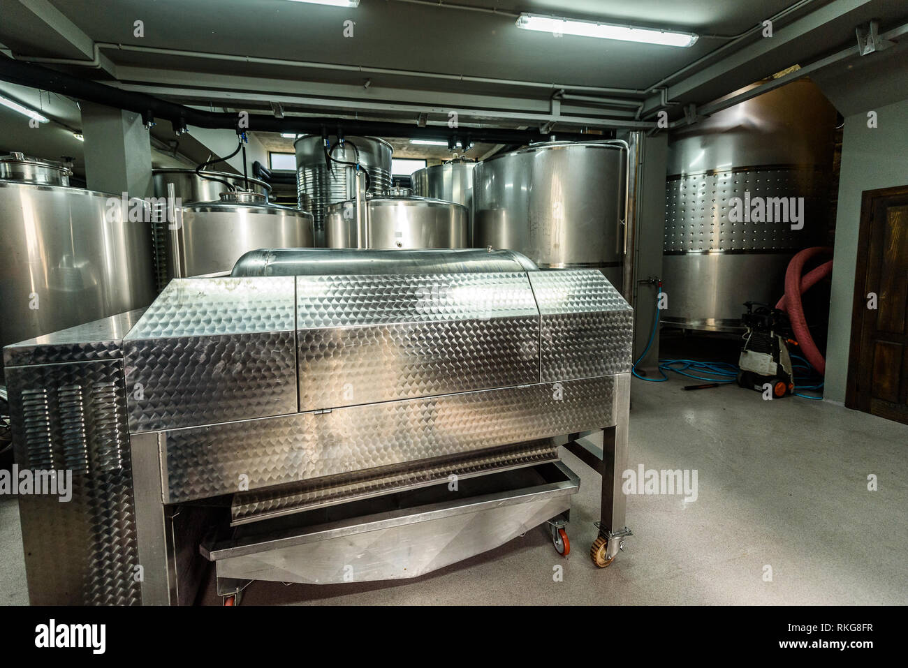 Inox wine barrels stacked in modern winery cellar in Spain. Modern ...
