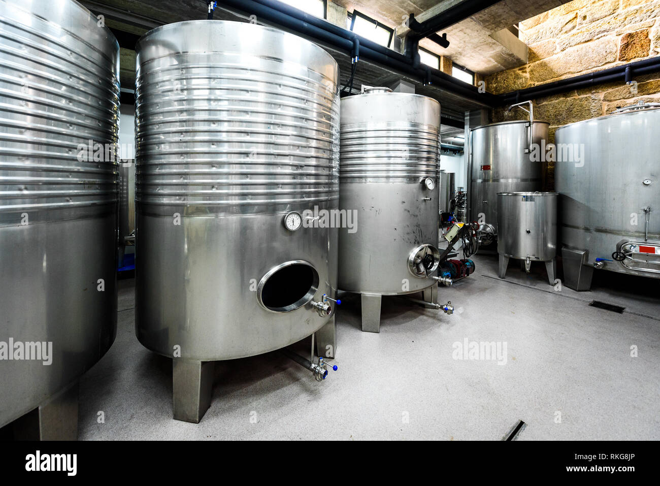Inox wine barrels stacked in modern winery cellar in Spain. Modern ...