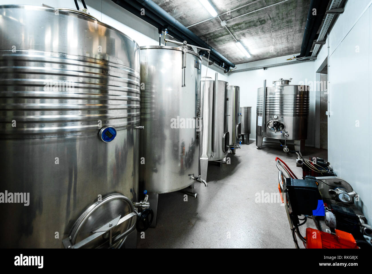 Inox wine barrels stacked in modern winery cellar in Spain. Modern ...