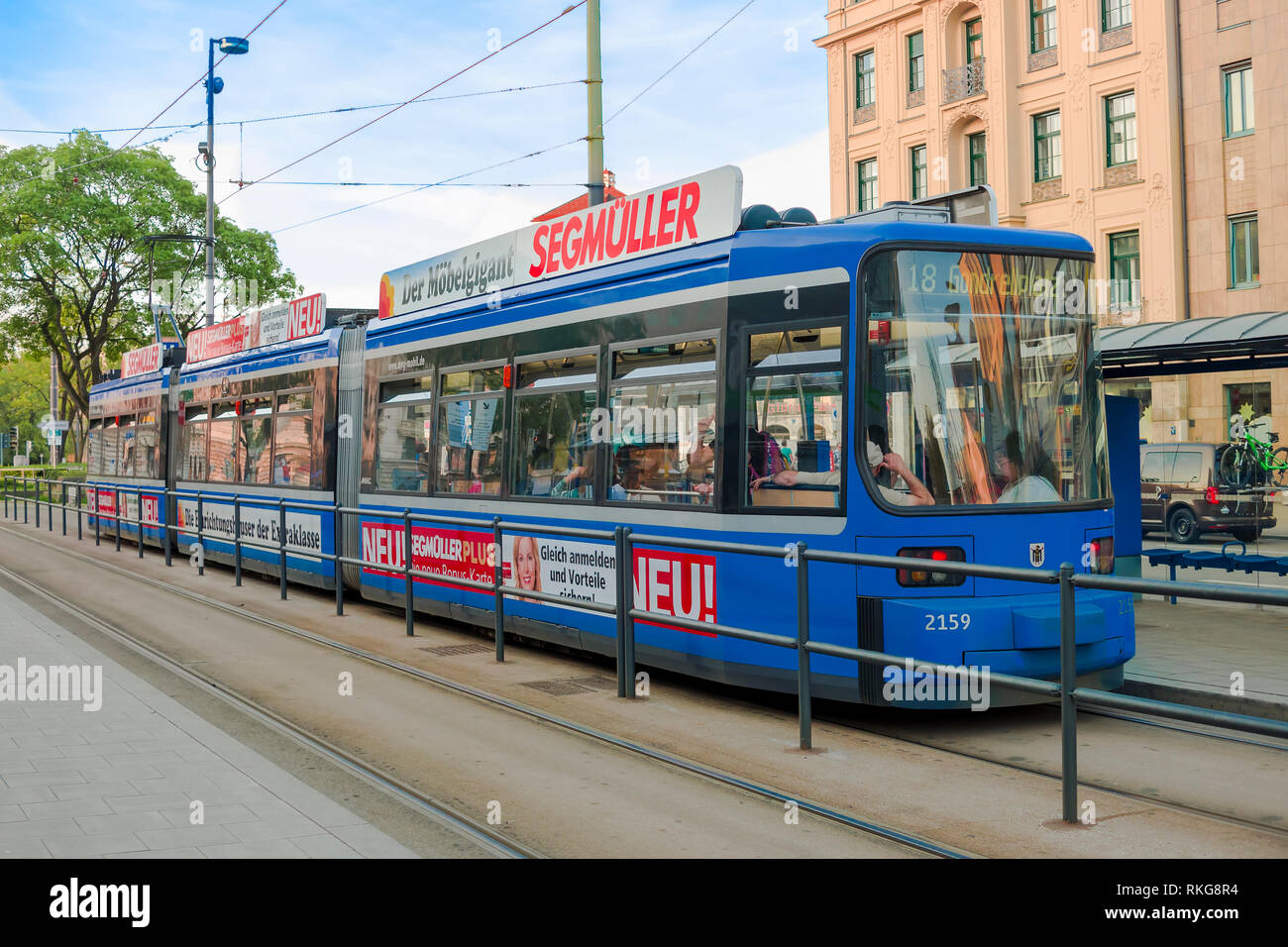 A view of a Line 18 blue tram car entering Karlplatz tram stop heading ...