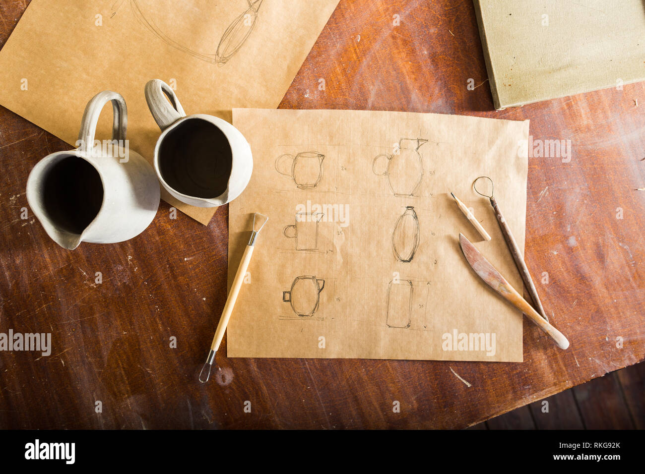 flat lay of clay pitchers, sketching of jugs made on Kraft paper and ...