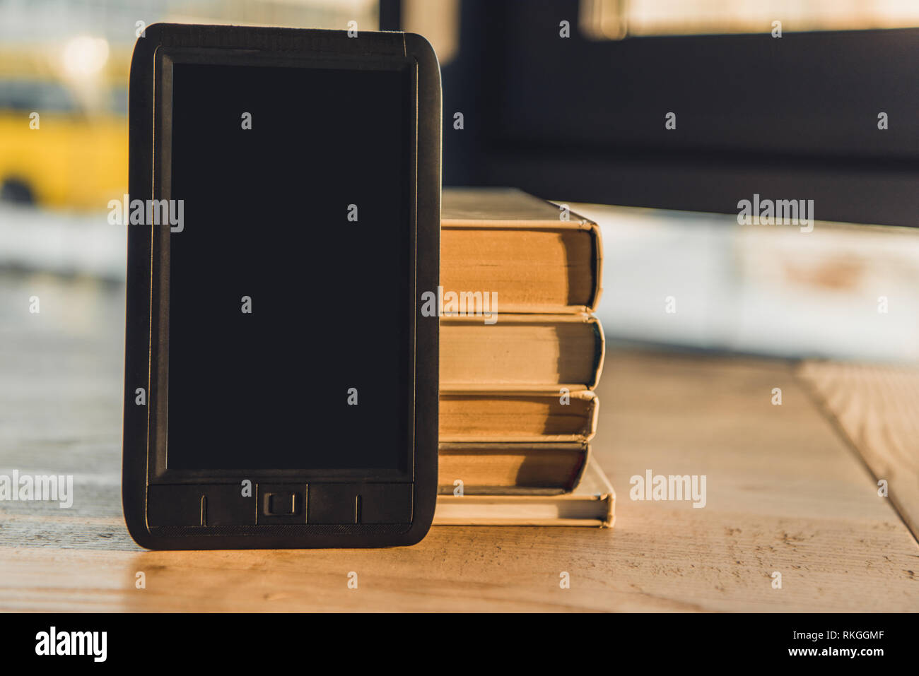 e-book with blank screen near paper books on table Stock Photo - Alamy