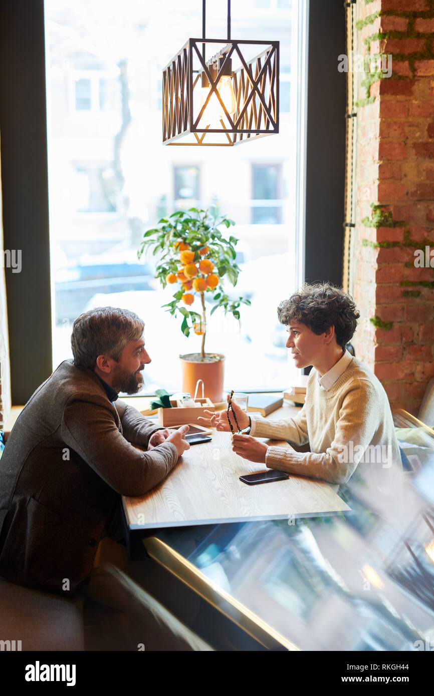 Talking by window Stock Photo - Alamy