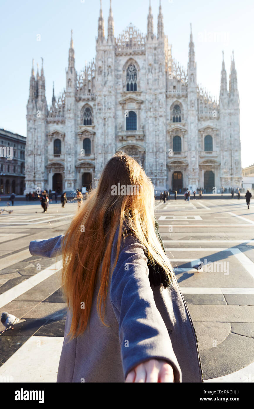 Travel tourist girl pulling hand on front of Duomo Milan Italy during ...