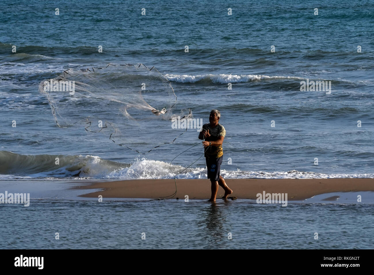 Man throwing fishing net into water hi-res stock photography and images ...