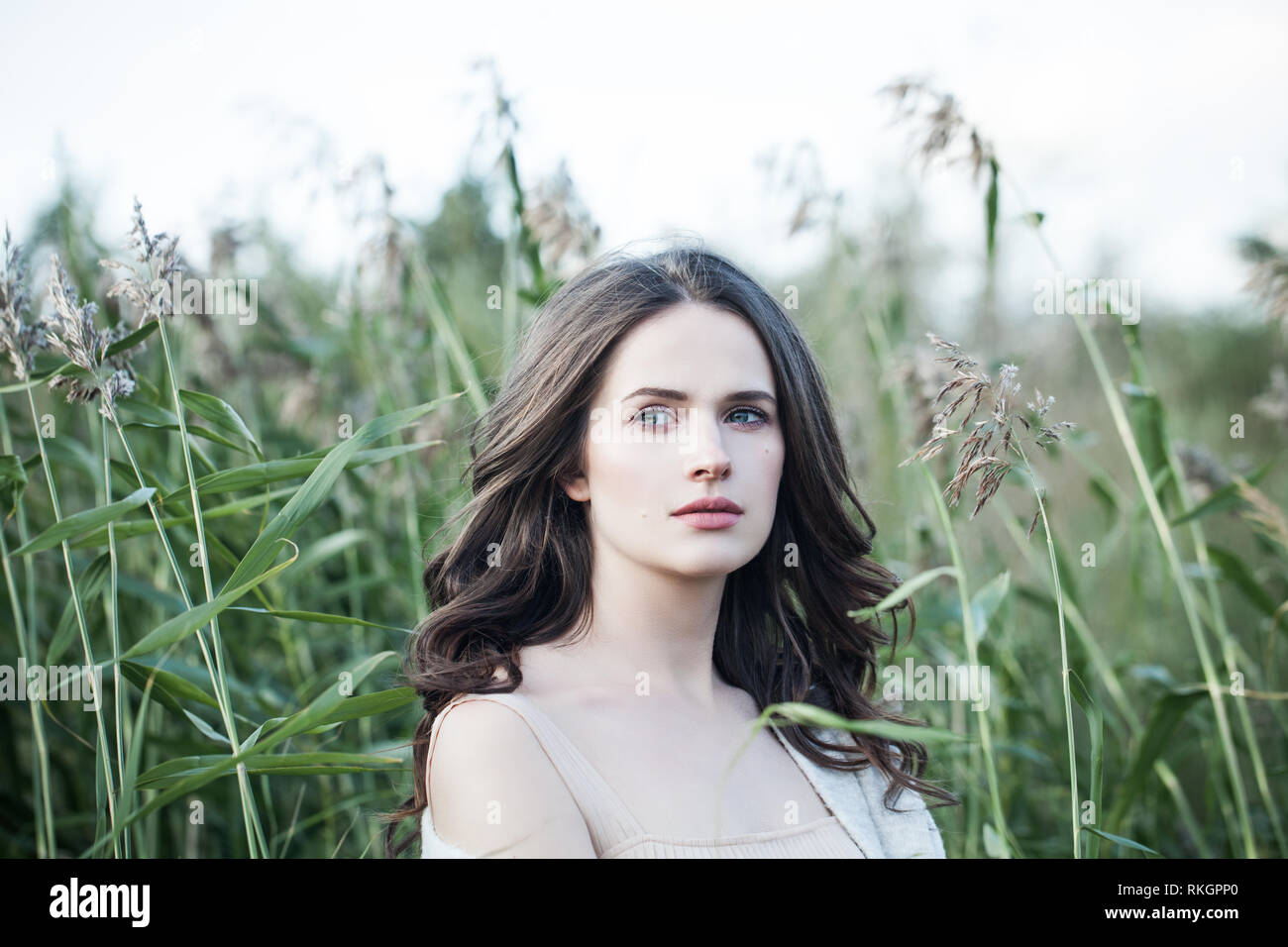 Lonely girl portrait. Spring woman walking alone outdoors on green ...