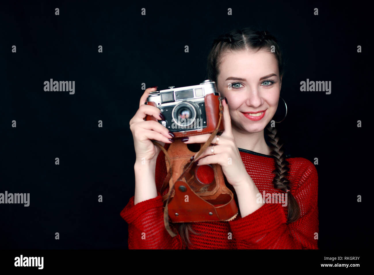 beautiful woman with a retro camera on a black background Stock Photo ...