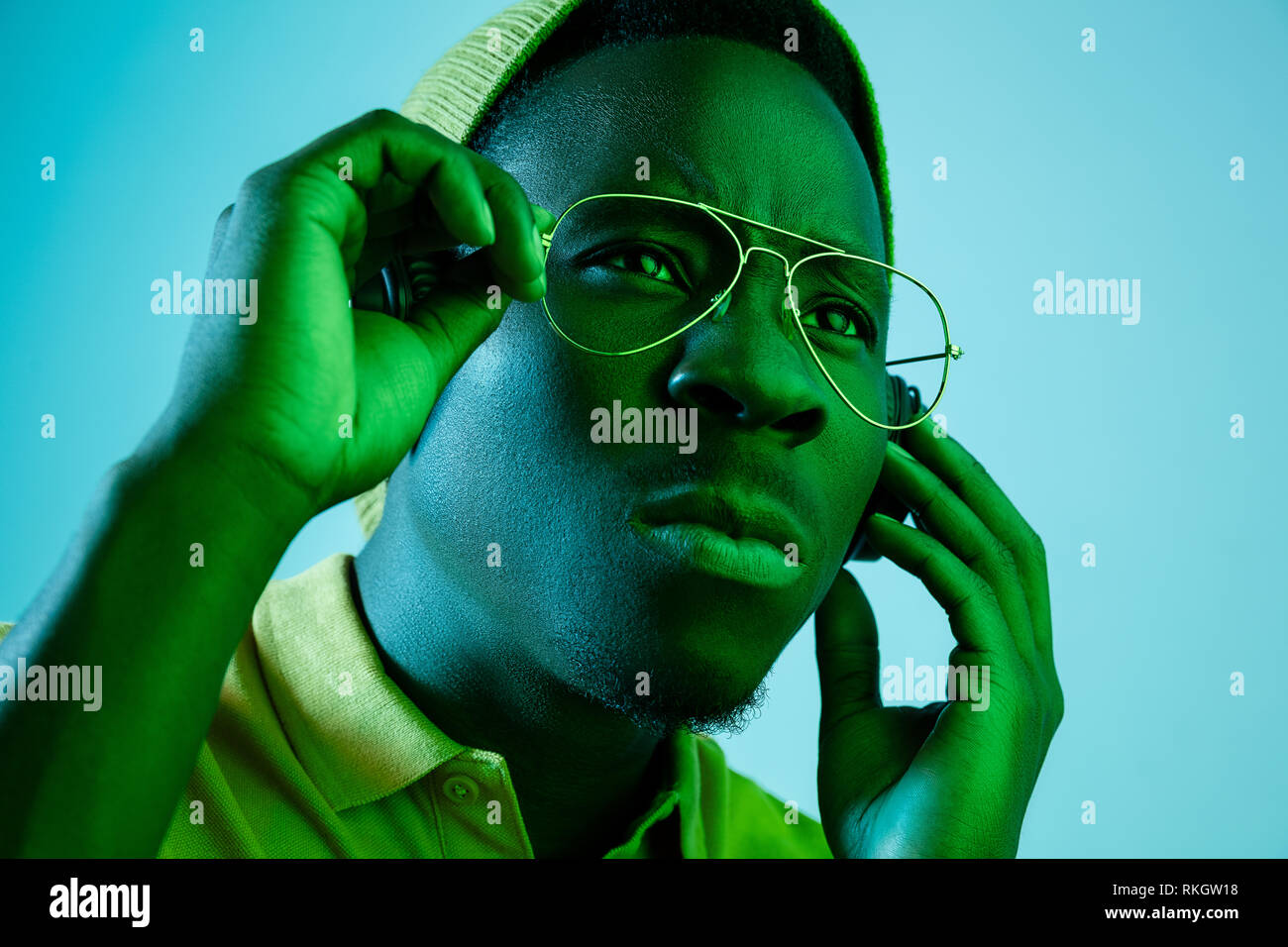 The young handsome serious sad hipster man listening music with ...