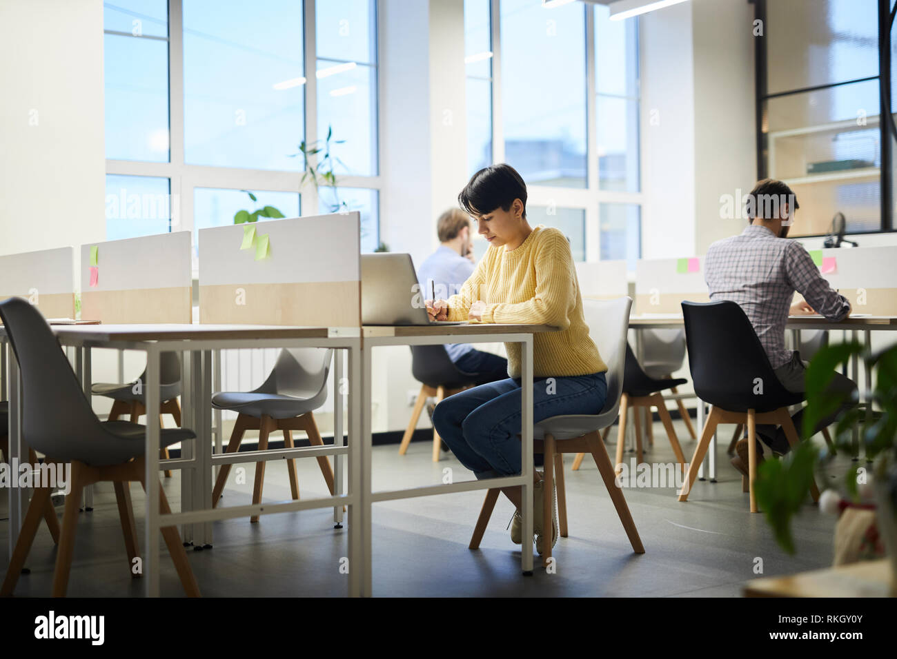 Student girl working on project in coworking space Stock Photo - Alamy