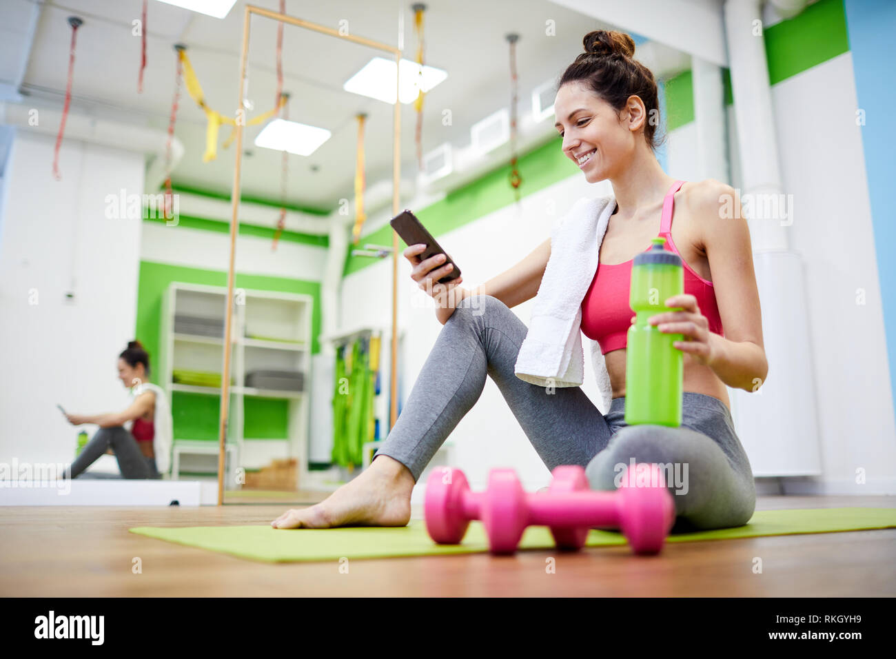 Smiling sportswoman holding towel hi-res stock photography and images - Alamy