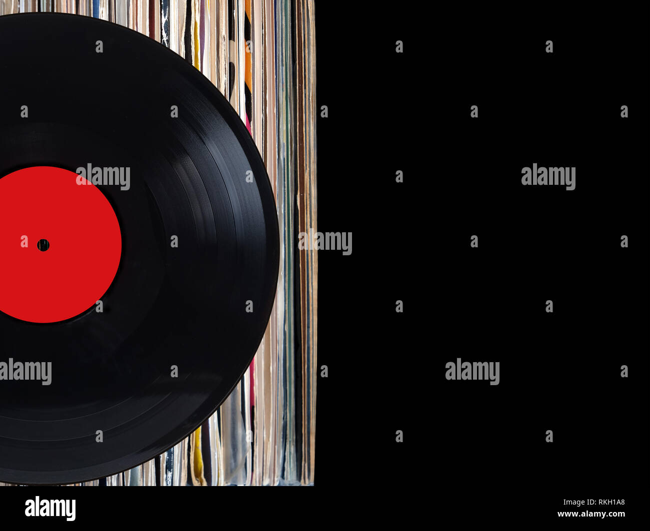 Black record with red label and pile of many close standing vinyl ...