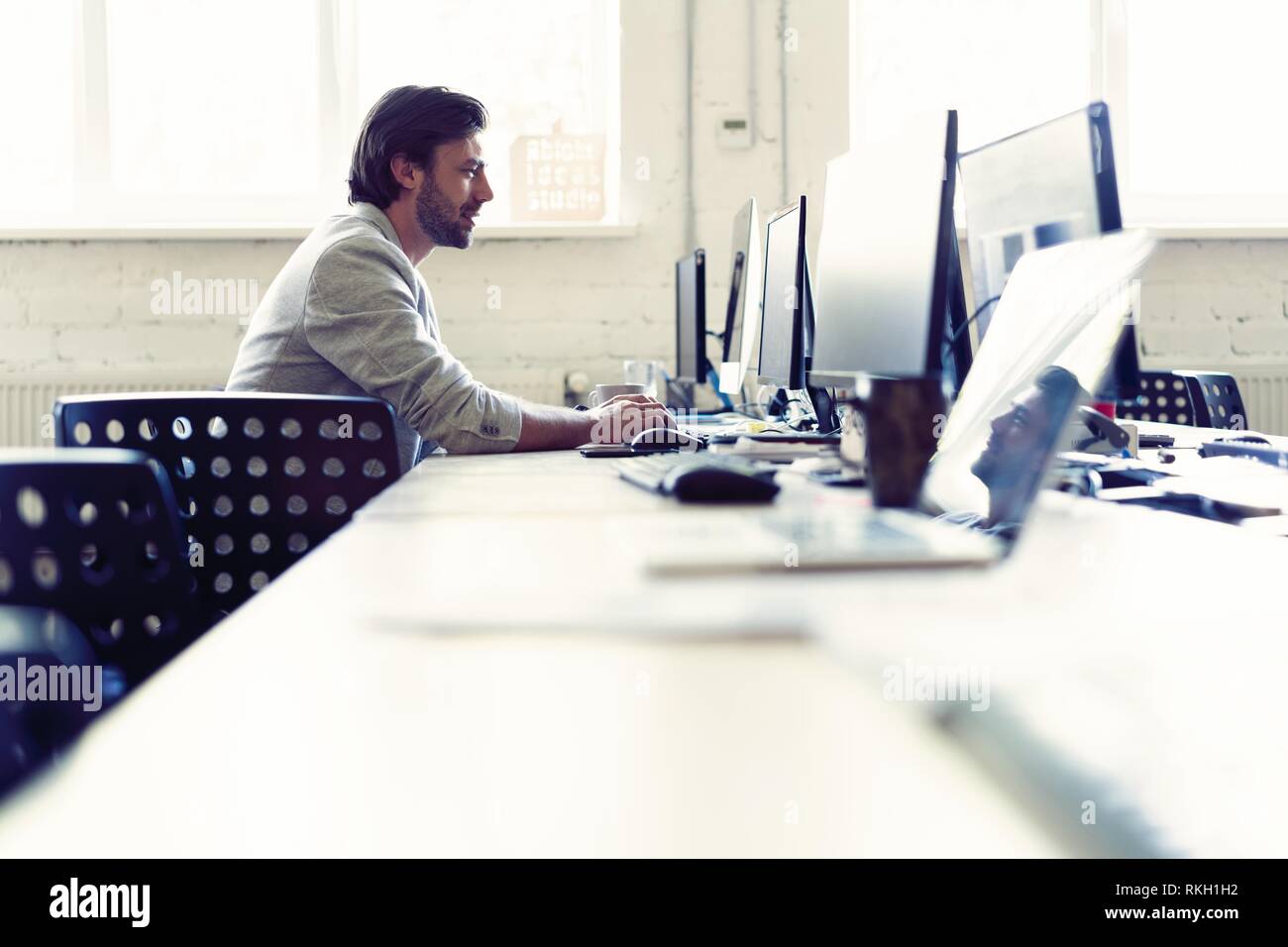Male office worker looking at computer screen with data. Concept of ...