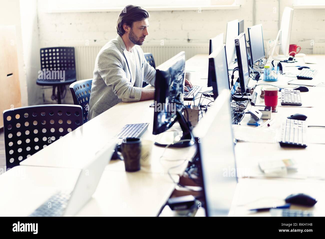 Male office worker looking at computer screen with data. Concept of ...