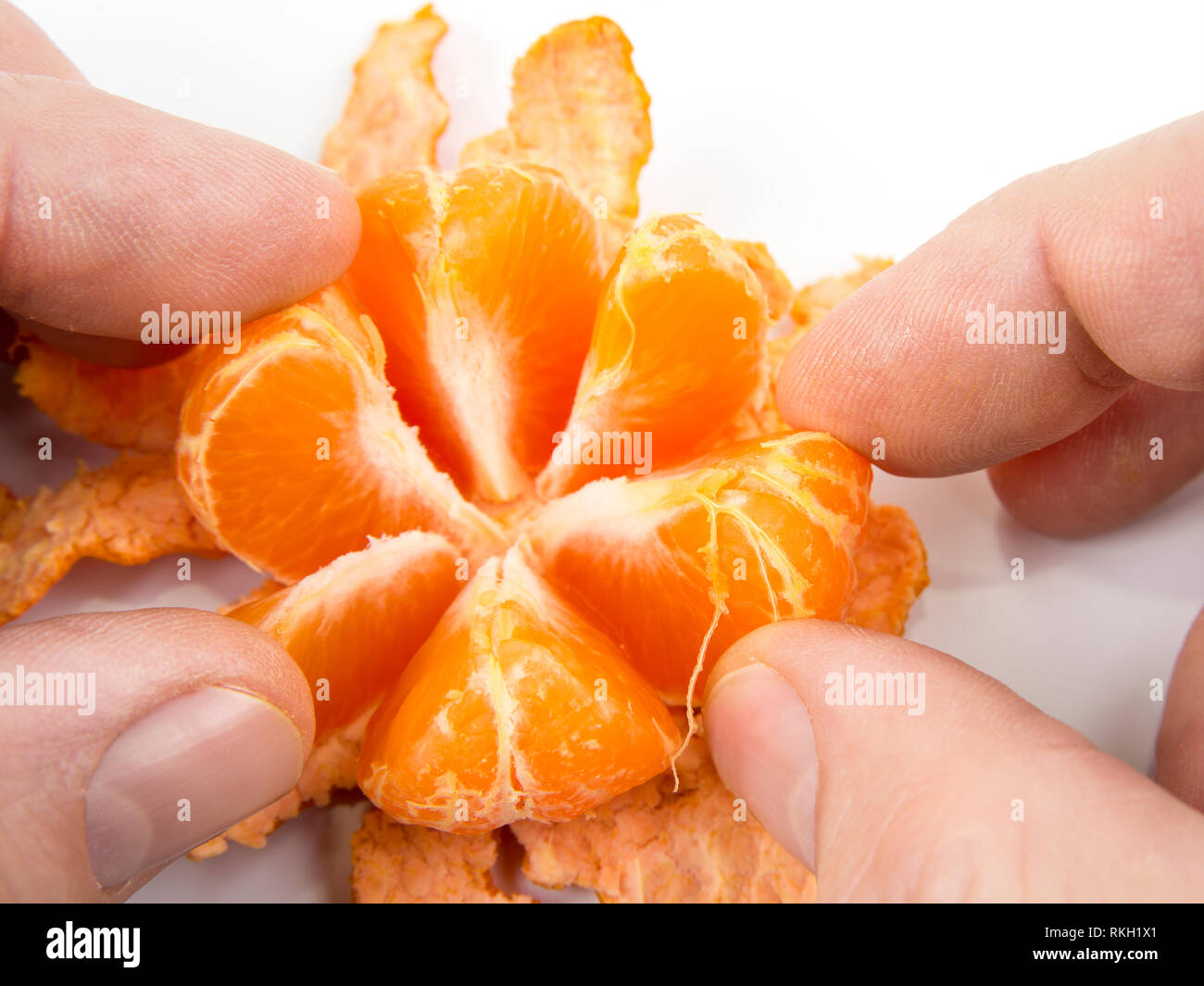 Peel of tangerine by hand on a white background Stock Photo - Alamy