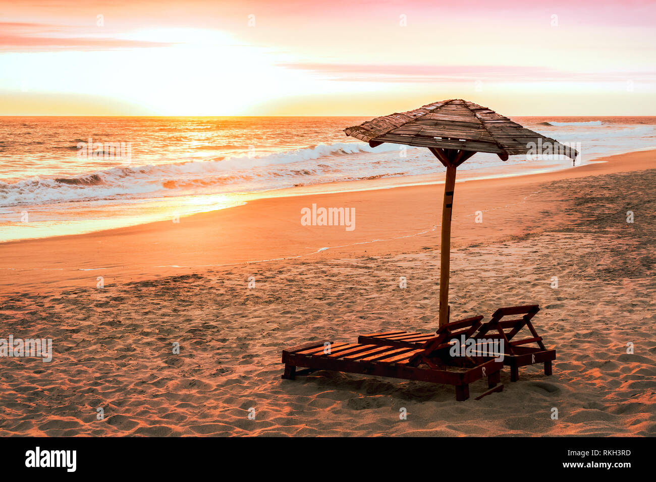 sunset on the pacific ocean of peru at punta rocas beach with deckchair ...