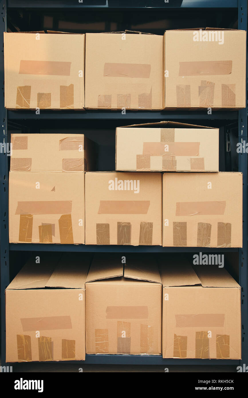 Cardboard boxes on shelves Stock Photo - Alamy