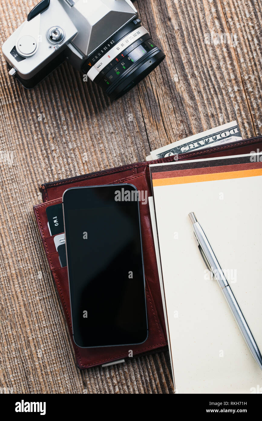 Smartphone with blank screen, camera, wallet, dollar banknotes, debit ...