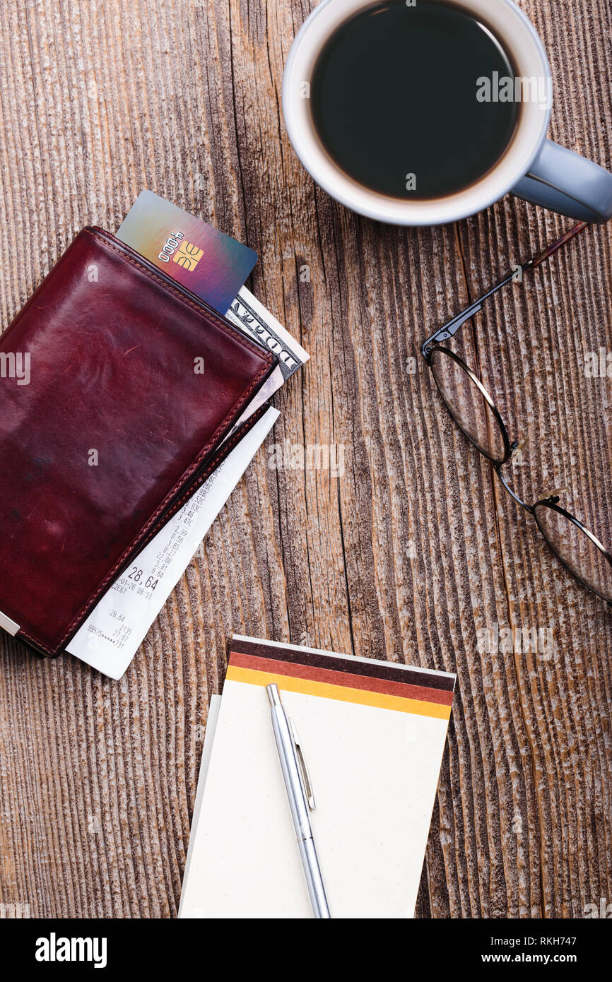 Leather wallet with dollar banknotes, credit card and receipt, glasses ...