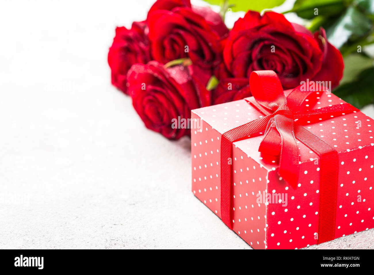 Red roses flower and present box on white Stock Photo - Alamy