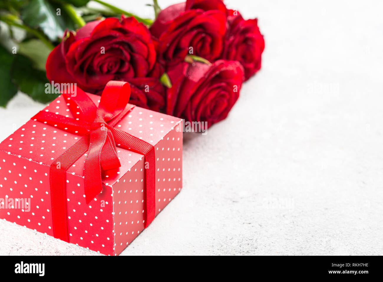 Red roses flower and present box on white Stock Photo - Alamy