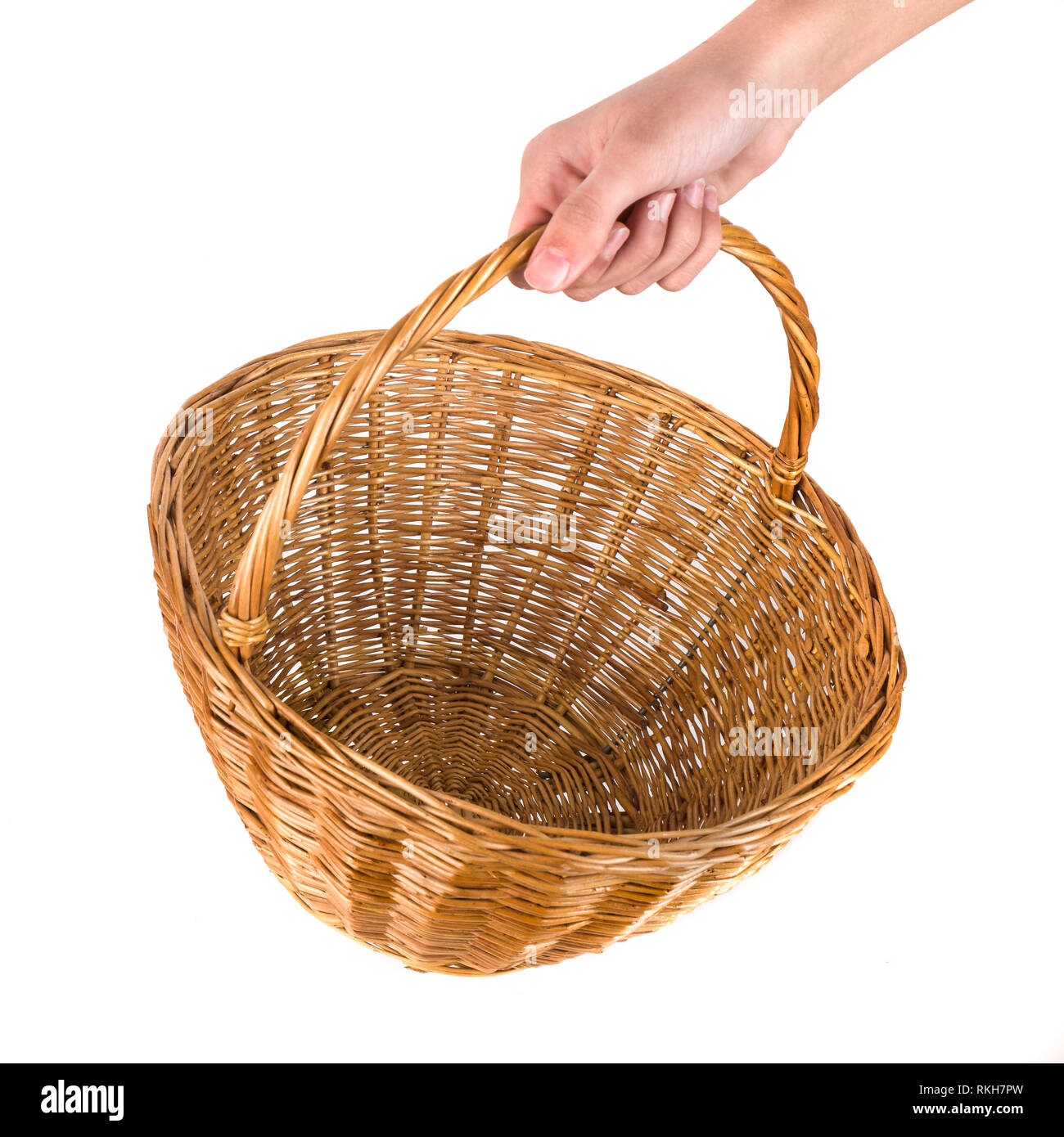 Empty wicker basket for fruits and vegetables in hand isolated on white ...
