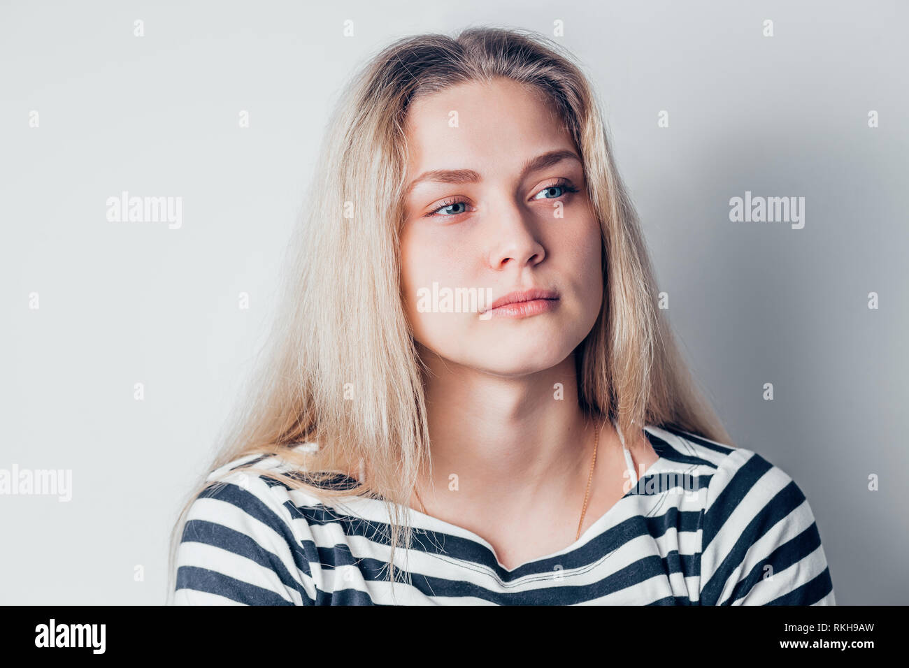 young beautiful sad woman serious and concerned looking aside and ...