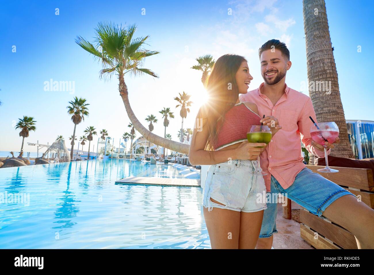 Couple drinking cocktail swimming pool hi-res stock photography and ...