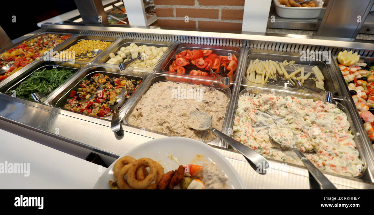 Inside a self service restaurant with many raw and cooked foods Stock ...