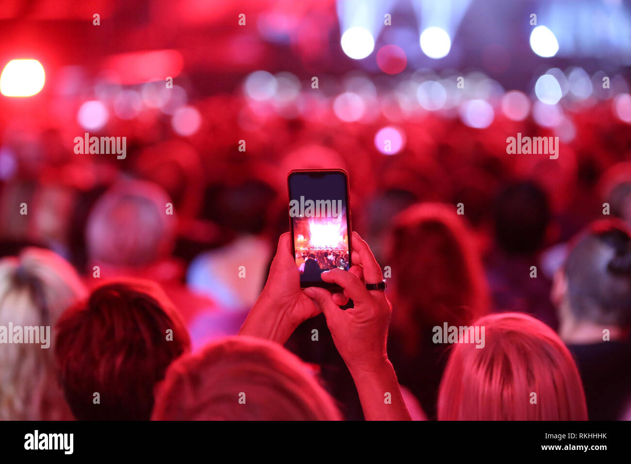 woman with smartphone during a live concert with a lot of people Stock ...