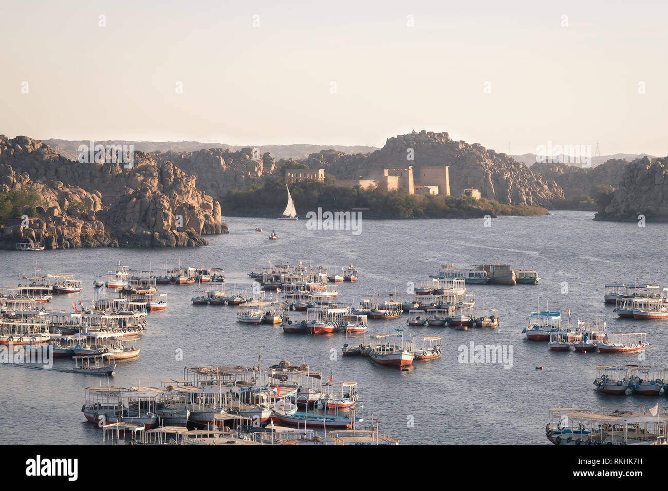 ISIS Temple at the Aswan Old Dam lake (Egypt) with traditional boats at ...