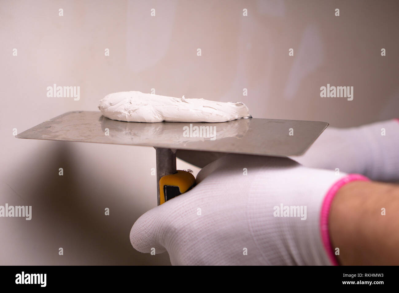 Hand with putty knife repair wall, Hand with a spatula, spatula with ...
