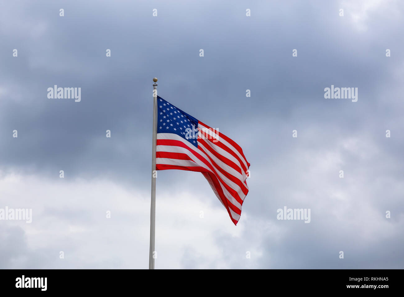 American Flag on the Cloudy background Stock Photo - Alamy
