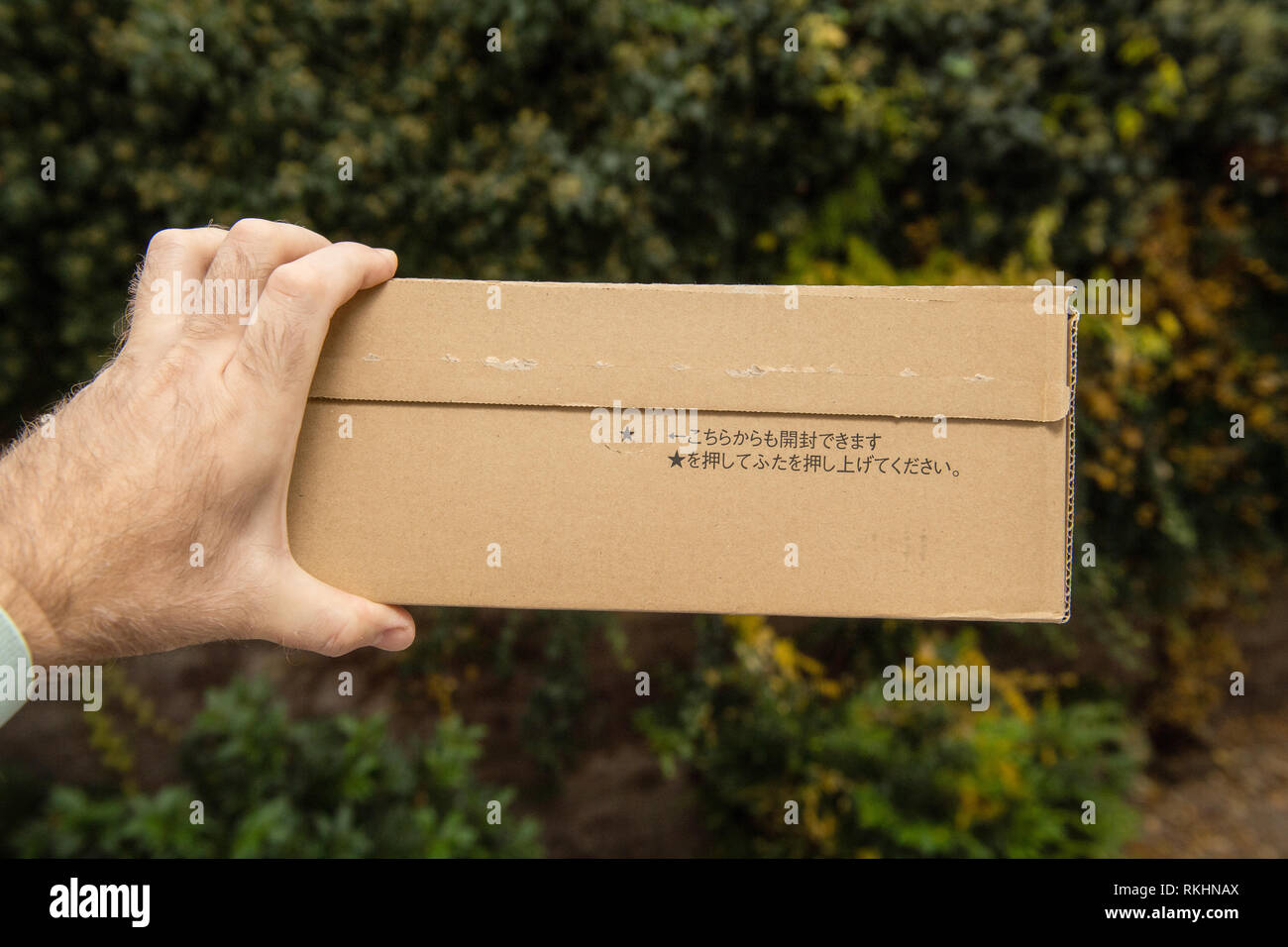 PARIS, FRANCE - NOV 15, 2018: Man holding the side of Amazon Japan ...