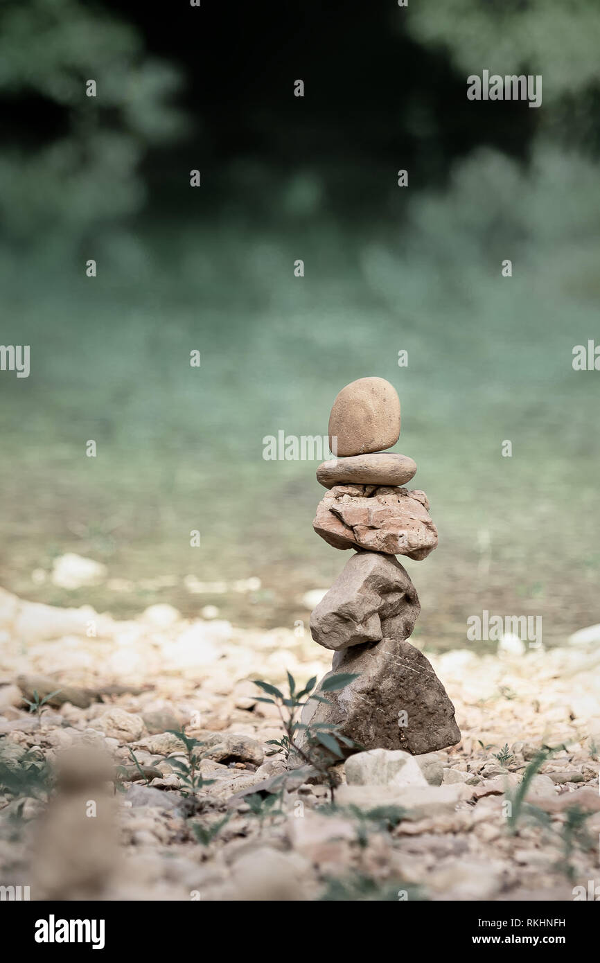 Stacked rocks by a river Stock Photo - Alamy
