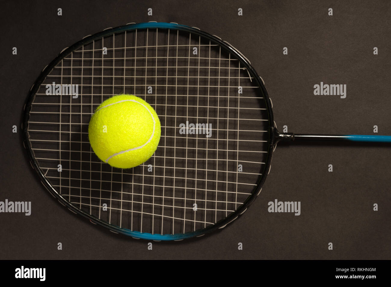 tennis ball and racket on dark background Stock Photo - Alamy