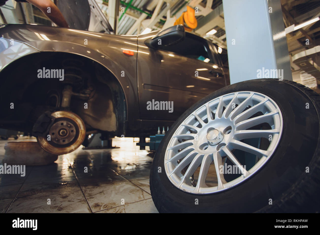 Car raised on car lift in autoservice Stock Photo - Alamy