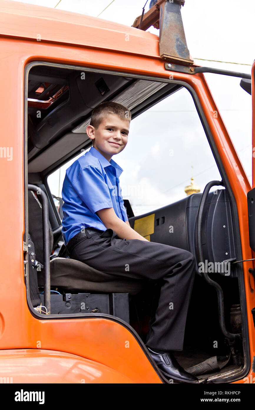 Cute smiling boy are sitting in fire engine Stock Photo - Alamy