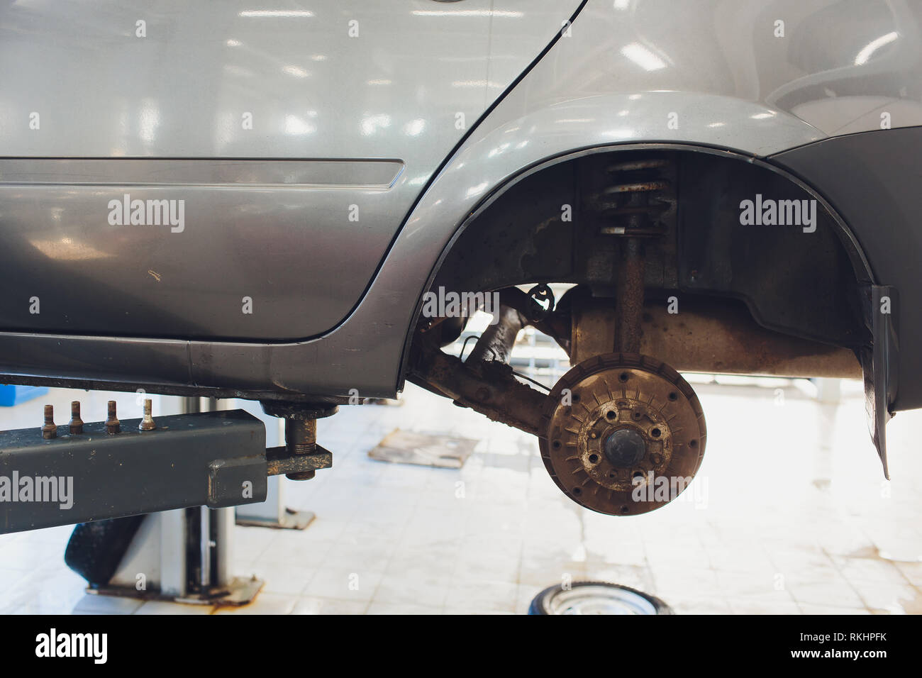 Car raised on car lift in autoservice Stock Photo - Alamy