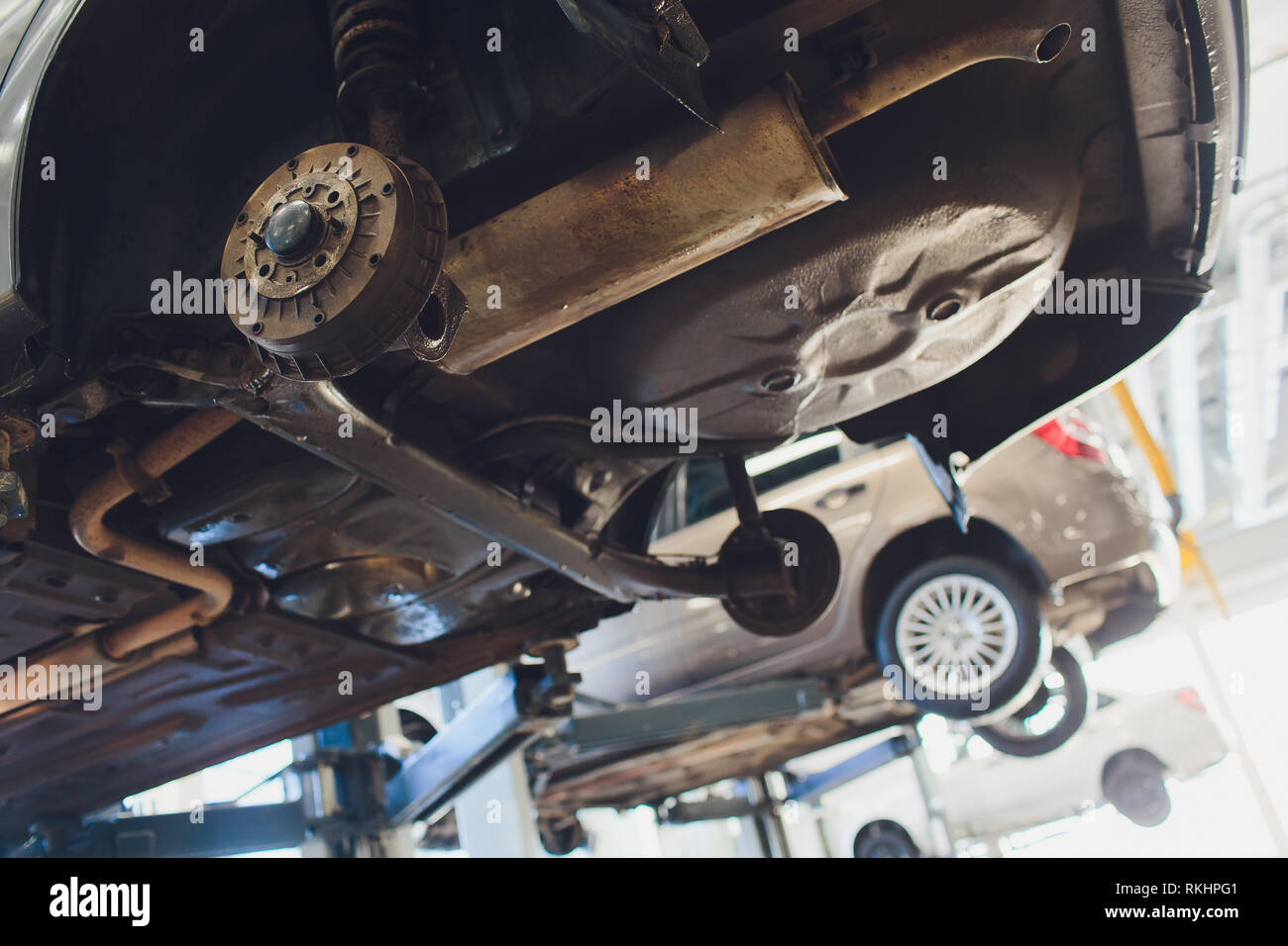 Car raised on car lift in autoservice Stock Photo - Alamy