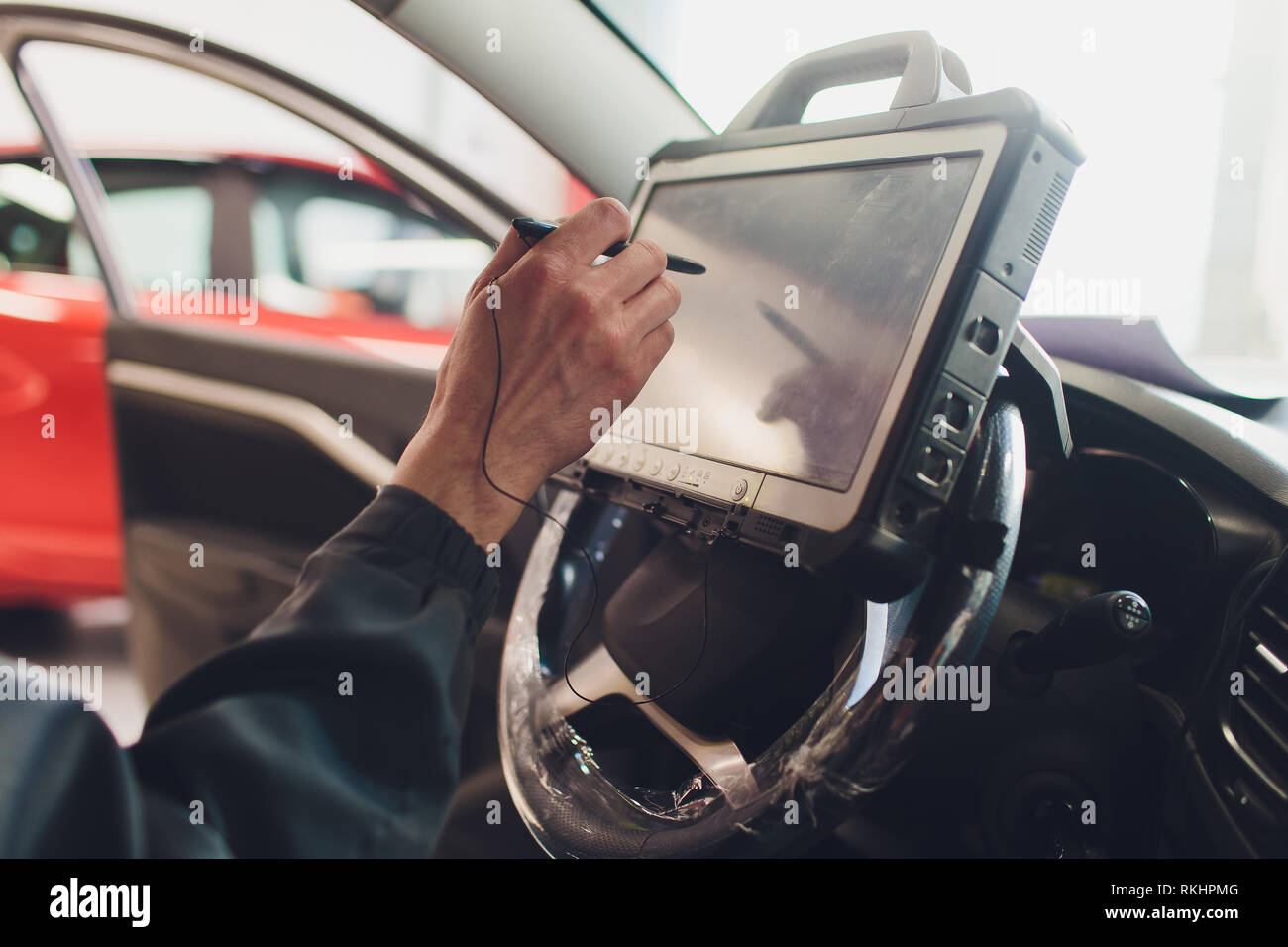 car mechanic maintains a vehicle with the help of a diagnostic computer ...