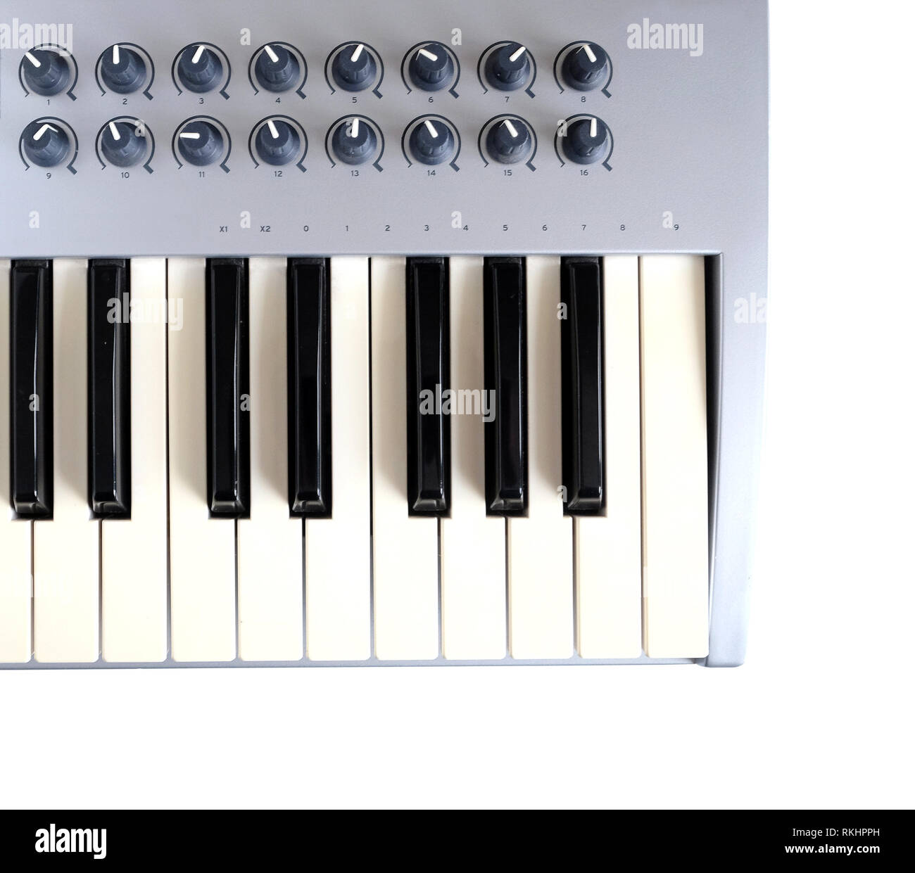 Fragment of electronic synthesizer keyboard with many control buttons ...